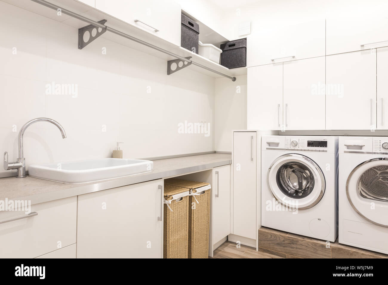 Laundry room with washing machine in modern house Stock Photo - Alamy