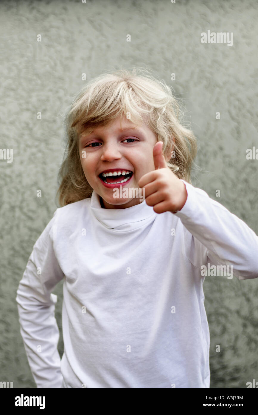 blond girl showing a yes sign Stock Photo - Alamy