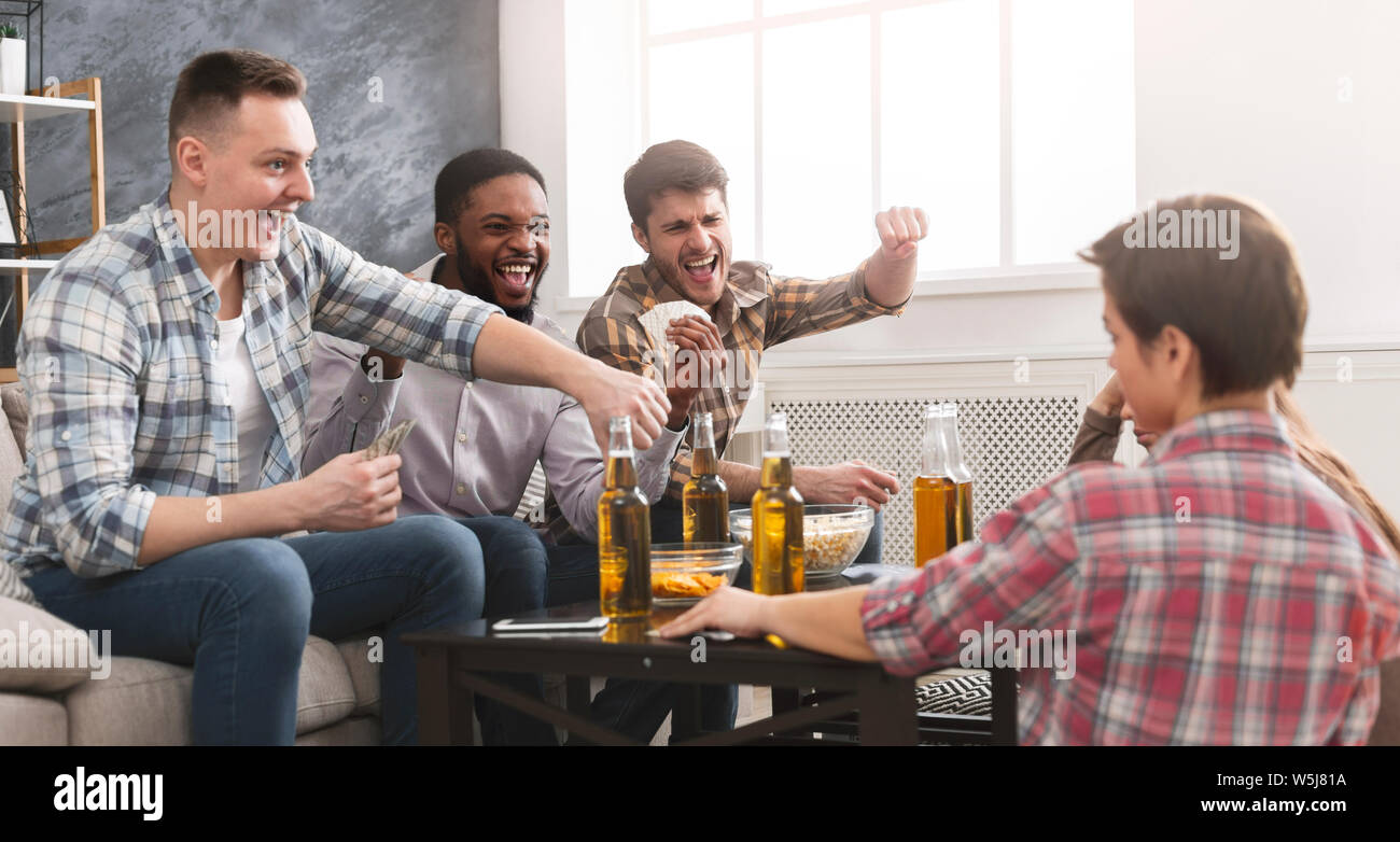 Group of multinational friends playing cards together Stock Photo - Alamy
