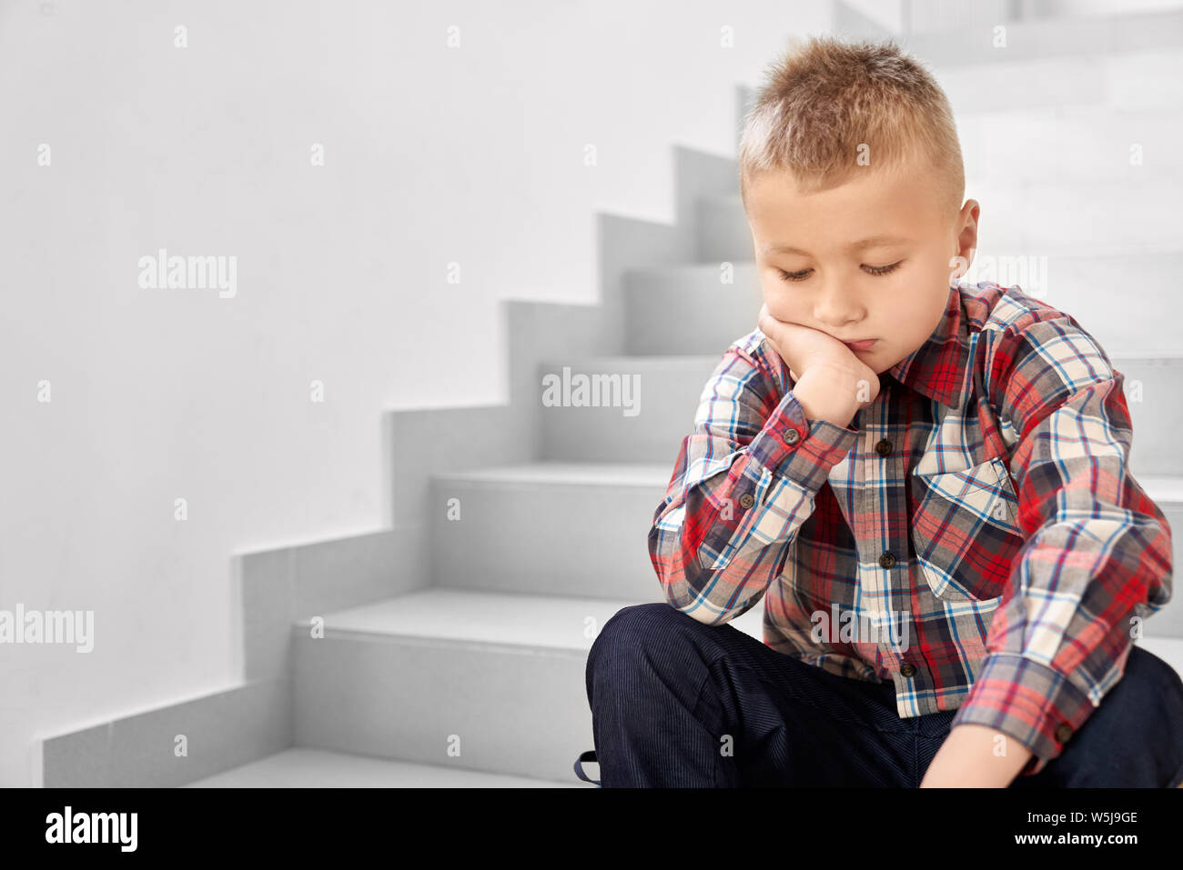 Sad lonely boy sitting on hi-res stock photography and images - Alamy
