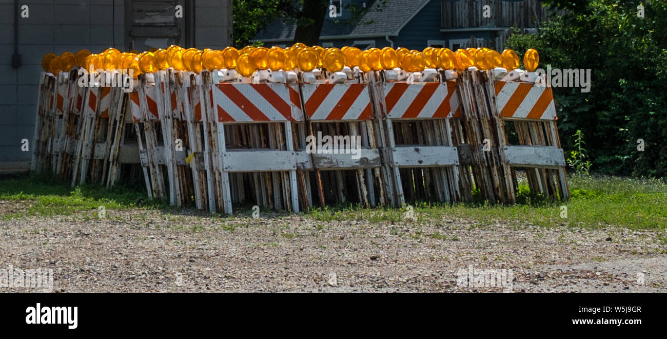 Old vintage obsolete construction barricades left stacked against an ...