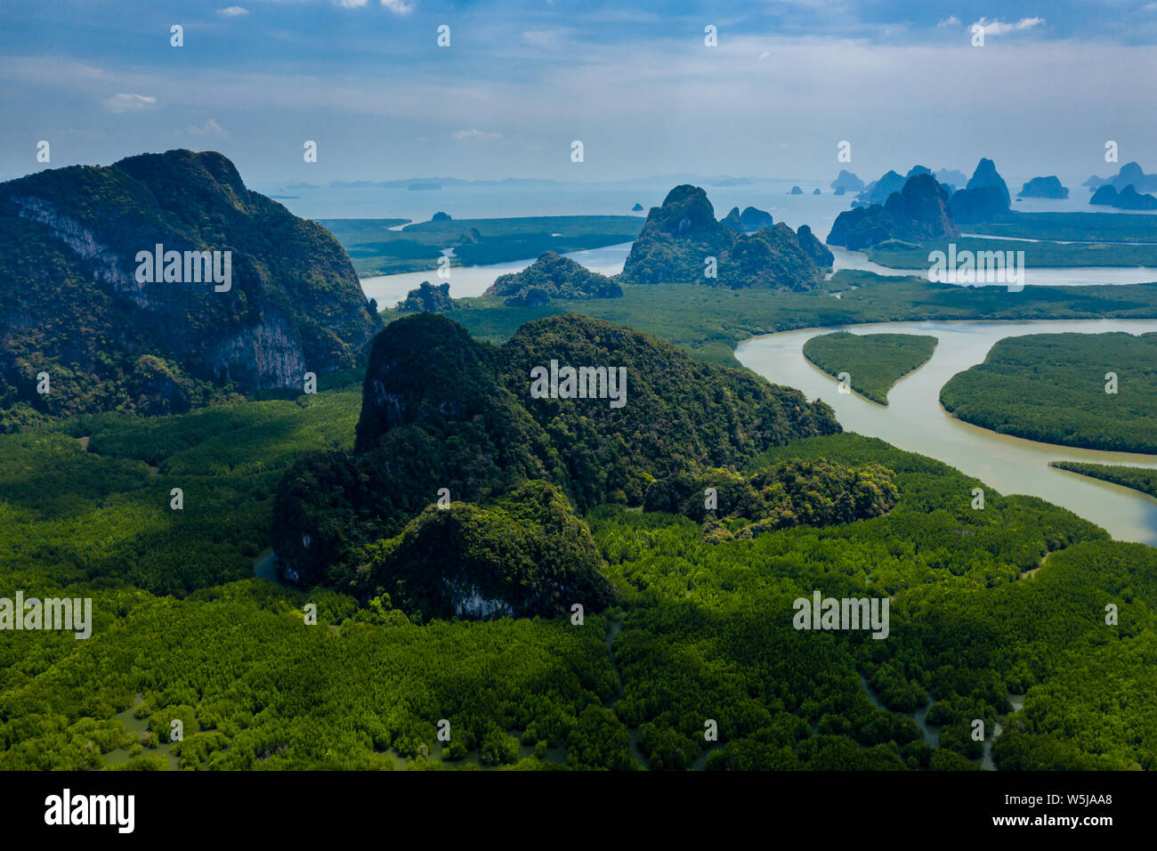 Aerial drone view of towering limestone cliffs and mangrove forest in ...