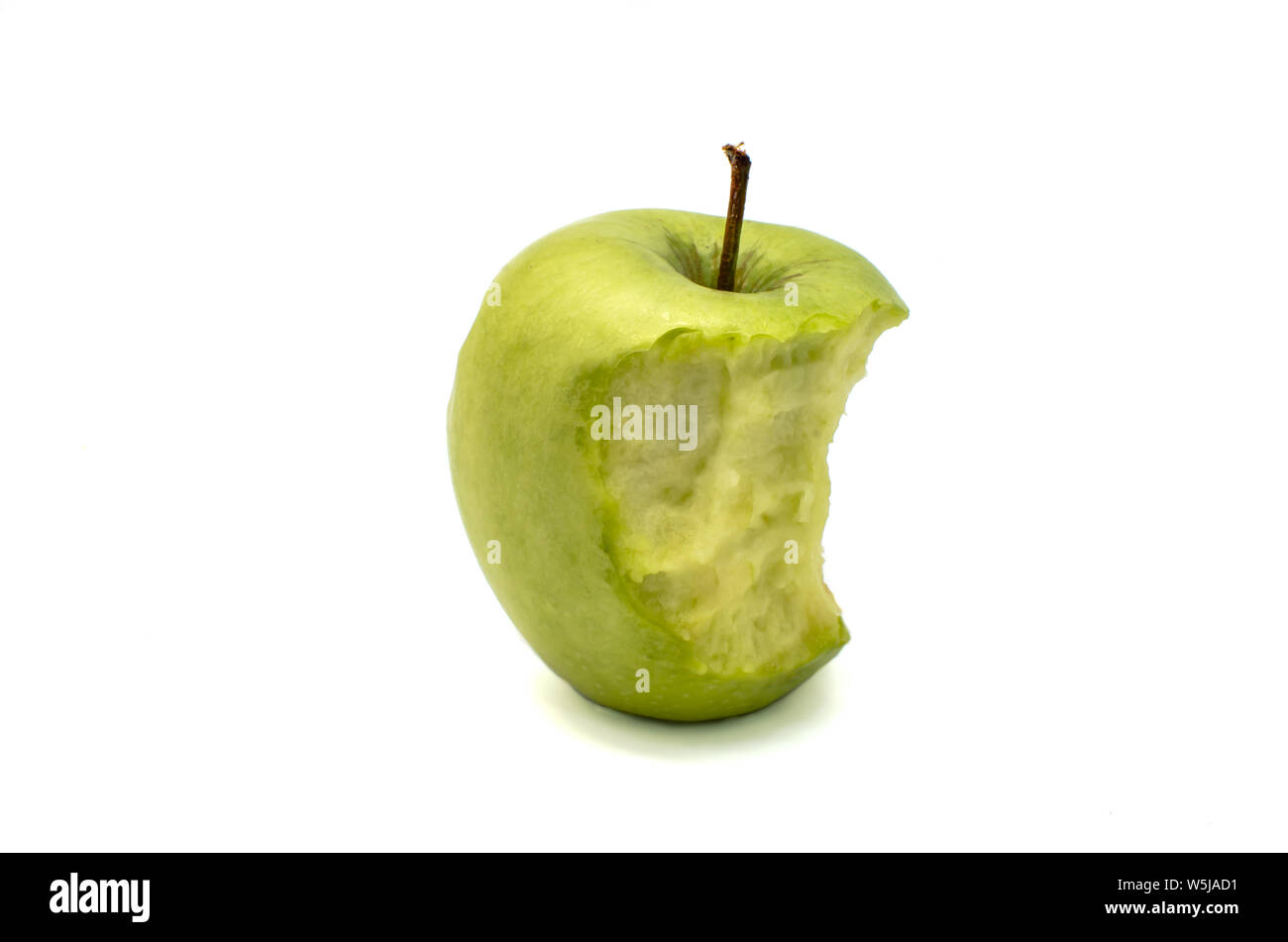 bitten green apple on white white white isolated Stock Photo - Alamy