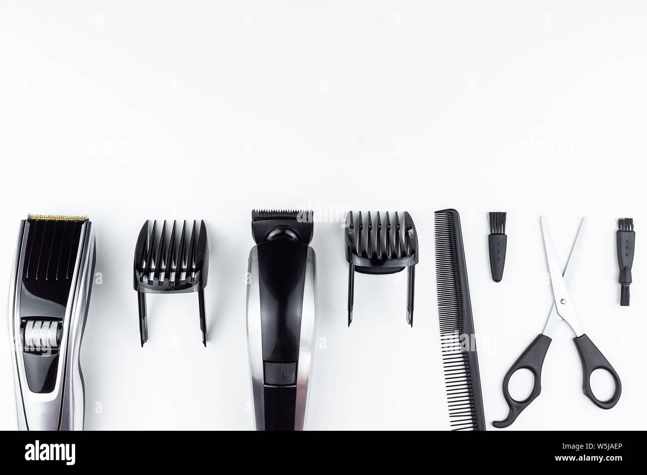 machine for haircuts. On the table are scissors and a comb. Barbershop ...