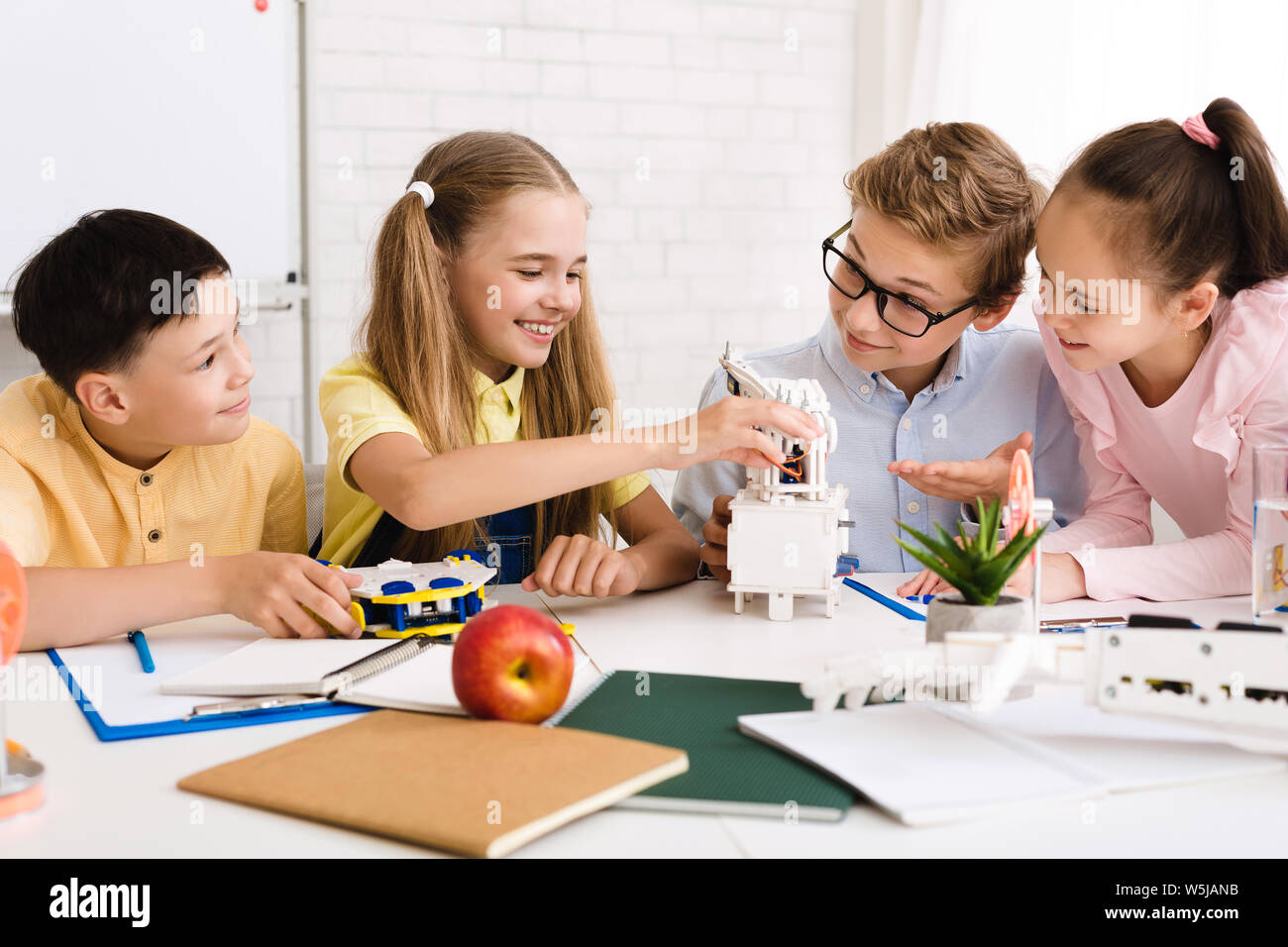 Happy children creating robots at class together Stock Photo - Alamy