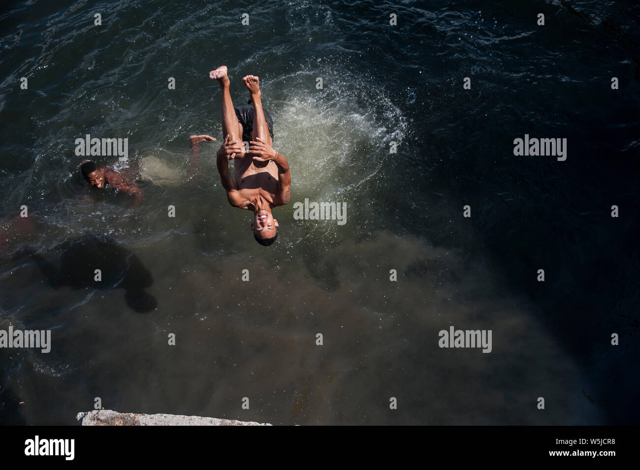 Teenage boy does a backflip into a river in Matanzas, Cuba while ...