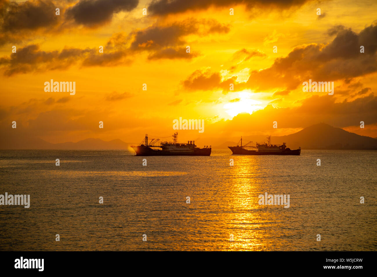 Fishing boats on sea in sunset lights in Sanya, Hainan, China Stock ...