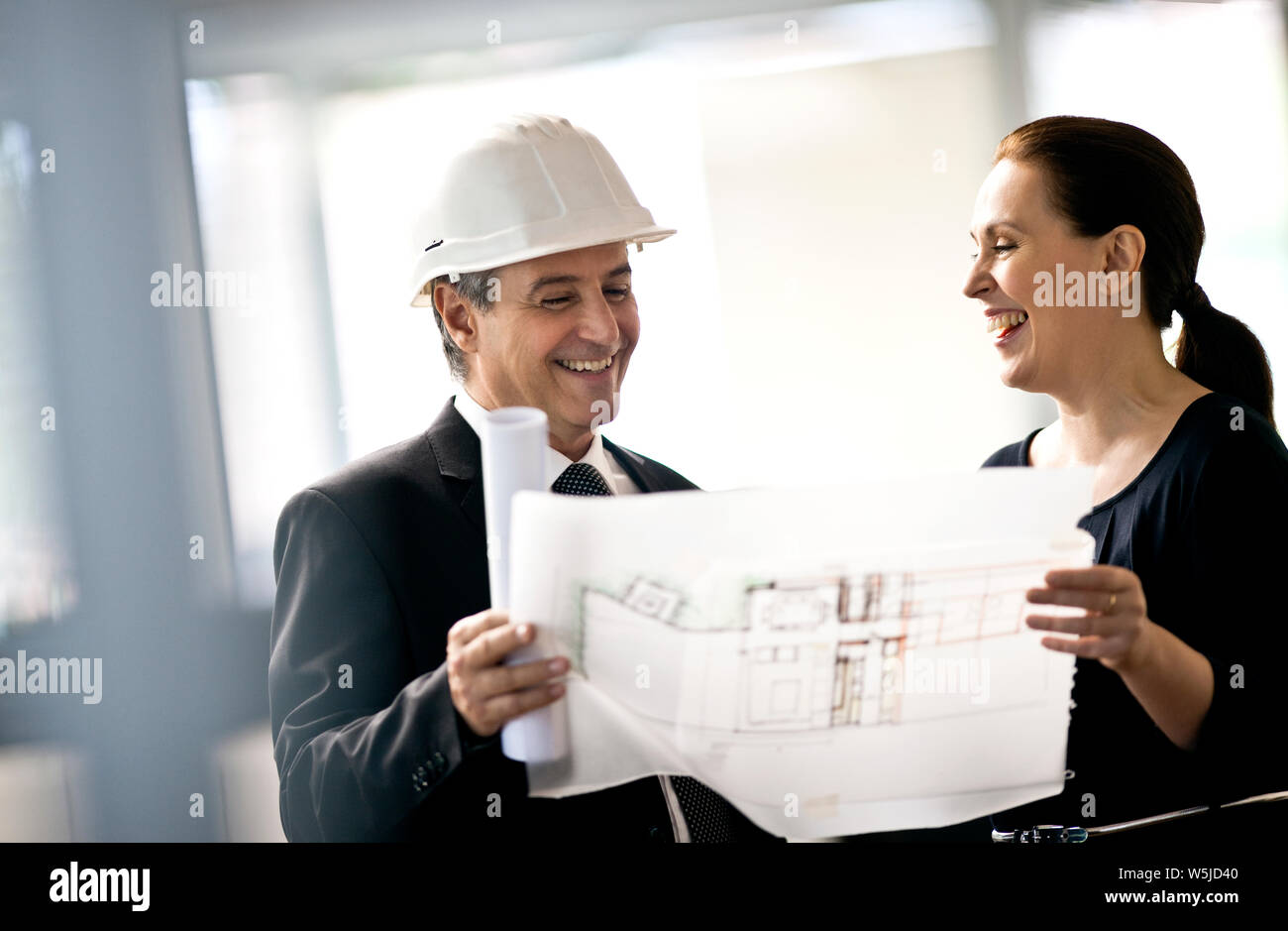 Female architect blueprints talking client hi-res stock photography and ...