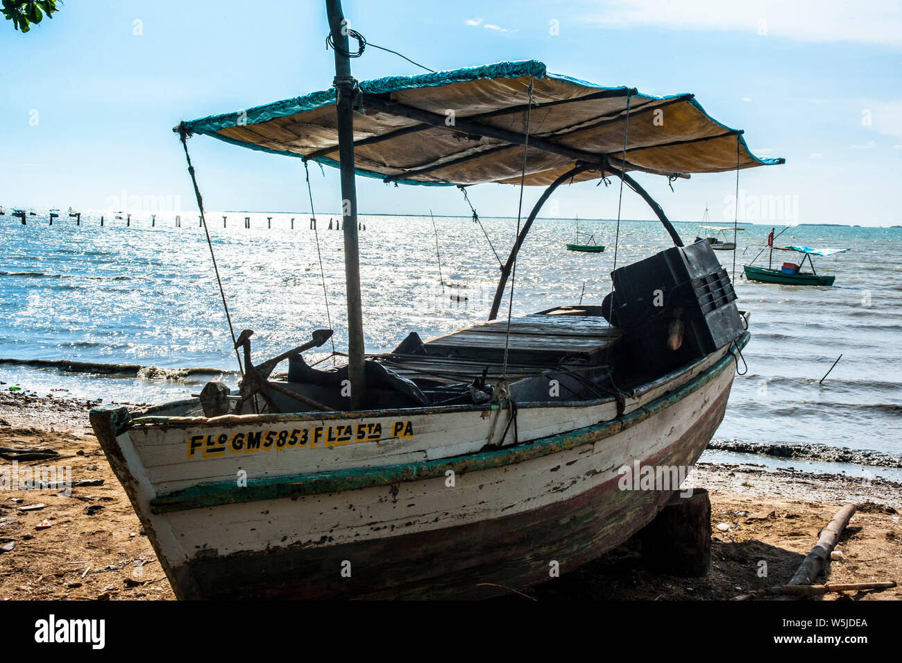 Fishing boat docked on the shore in Manzanillo, Cuba Stock Photo - Alamy