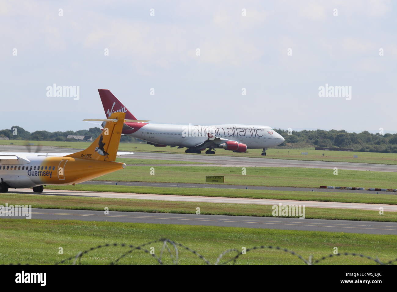 Virgin plane landing manchester airport hi-res stock photography and ...
