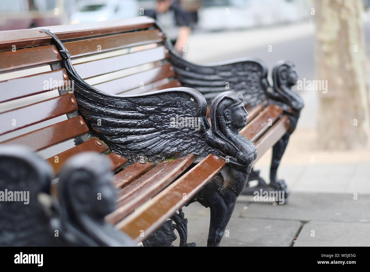 Wooden bench with figures of mythical heroes. London, UK Stock Photo ...
