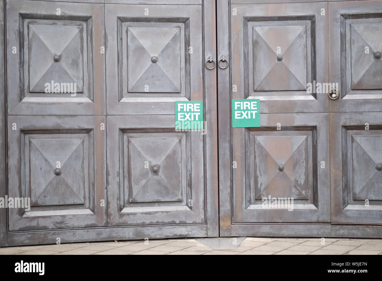 Plate "Fire exit" on massive wooden gates Stock Photo - Alamy