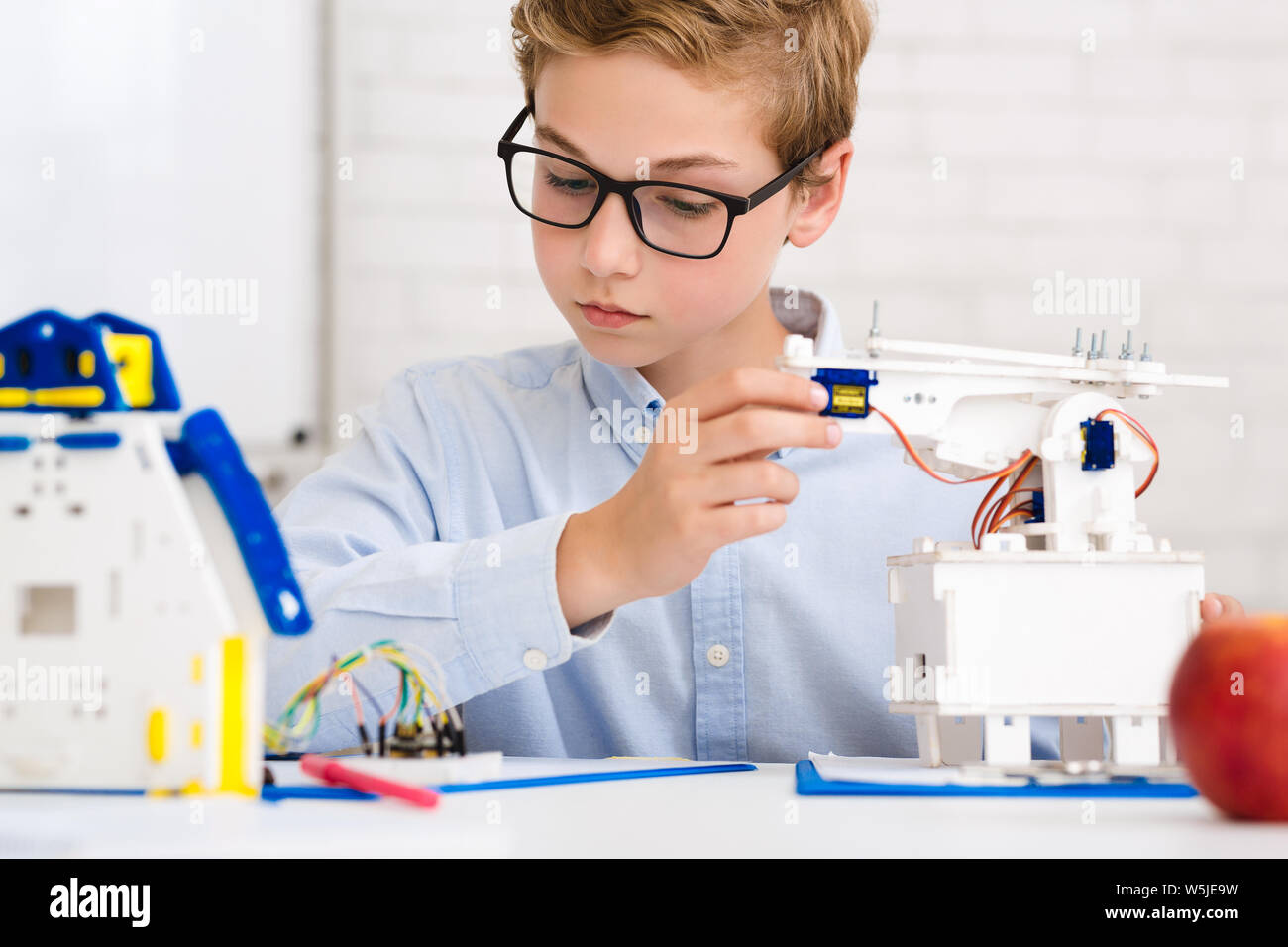 Schoolboy constructing electronic robot at stem lab Stock Photo - Alamy