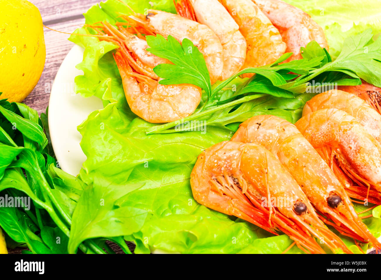 Cooked Atlantic prawns served with parsley and lemon salad Stock Photo ...