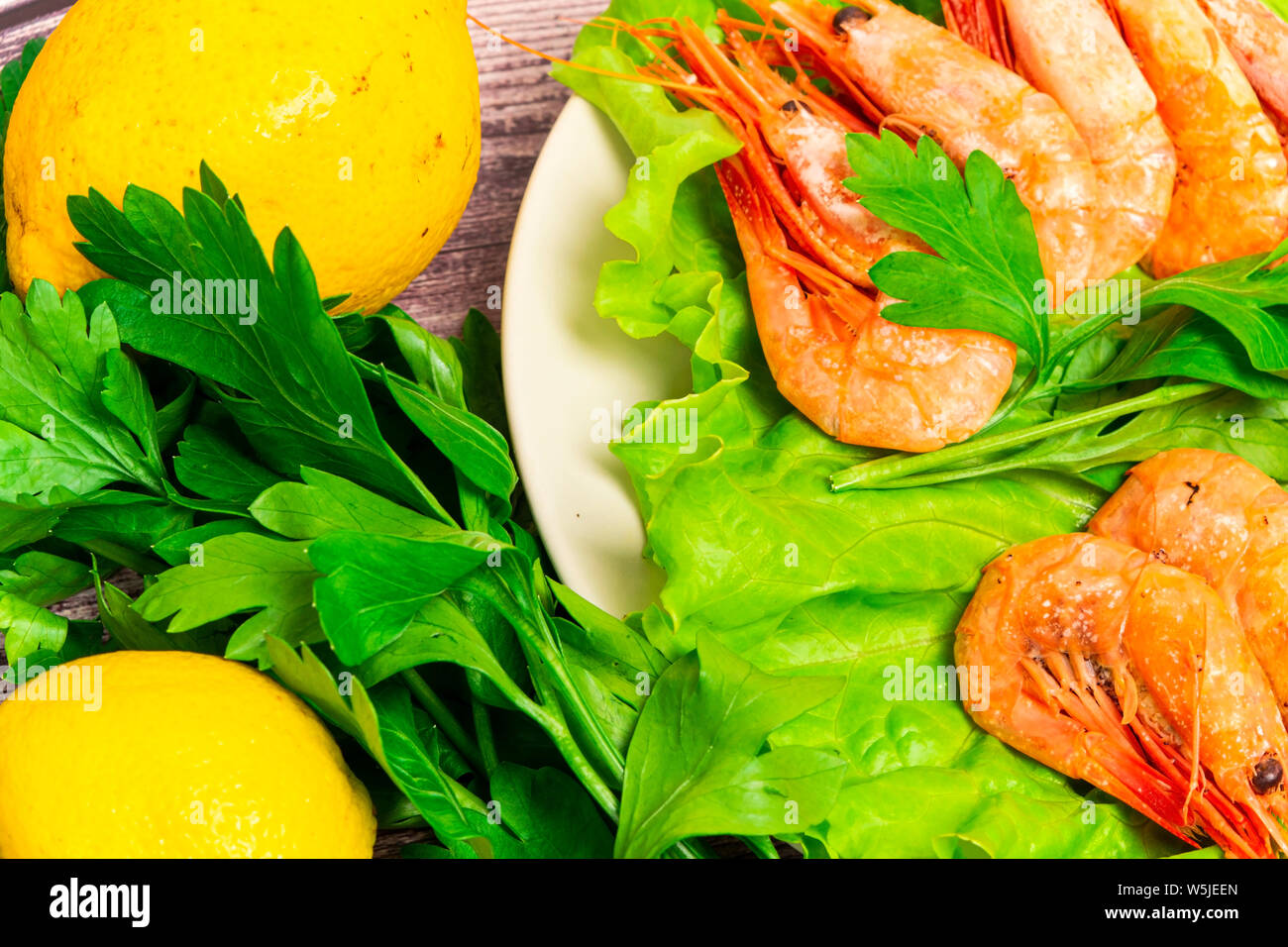 Cooked Atlantic prawns served with parsley and lemon salad Stock Photo ...