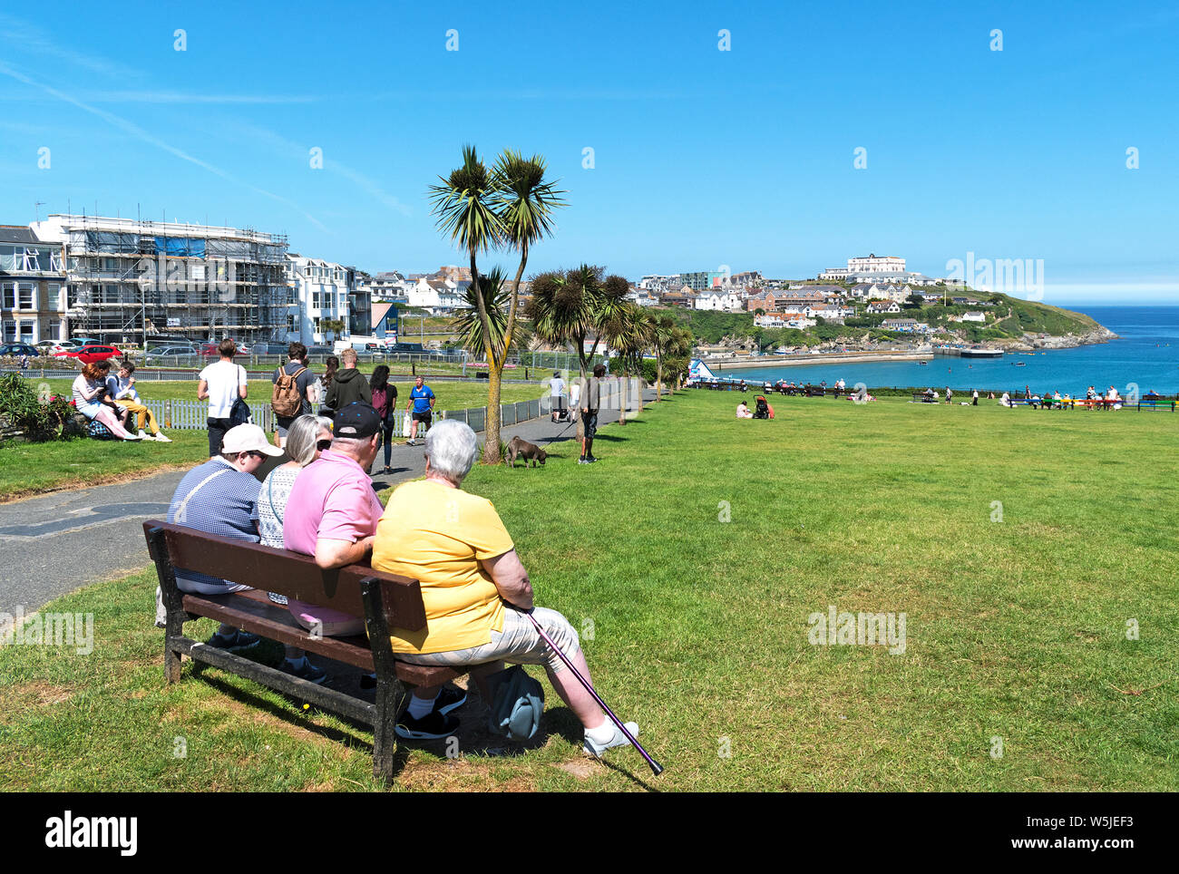 visitors enjoying the sunny summer weather at newquay in cornwall ...