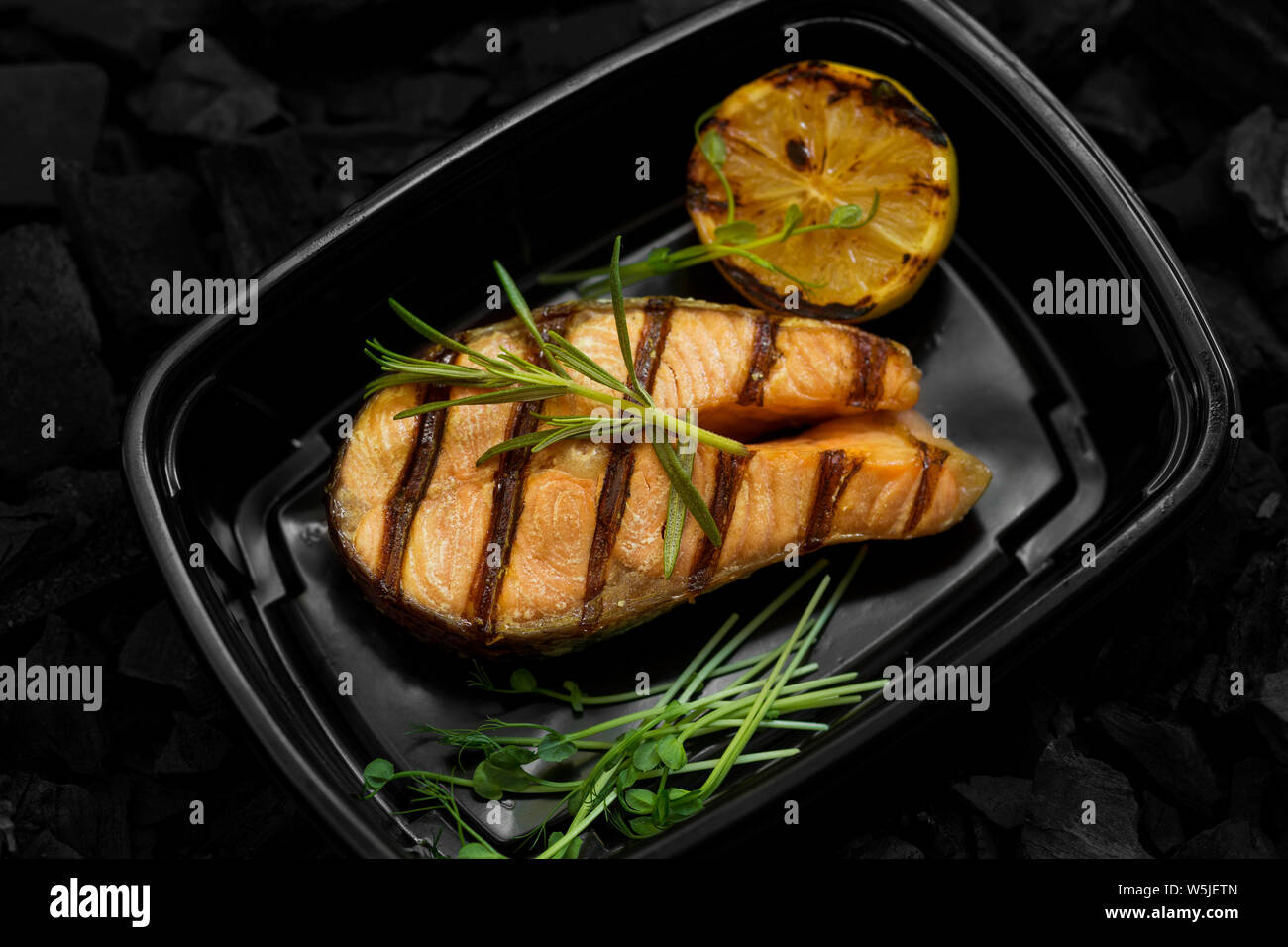 Coal prepared fish for healthy nutrition in take away box Stock Photo ...