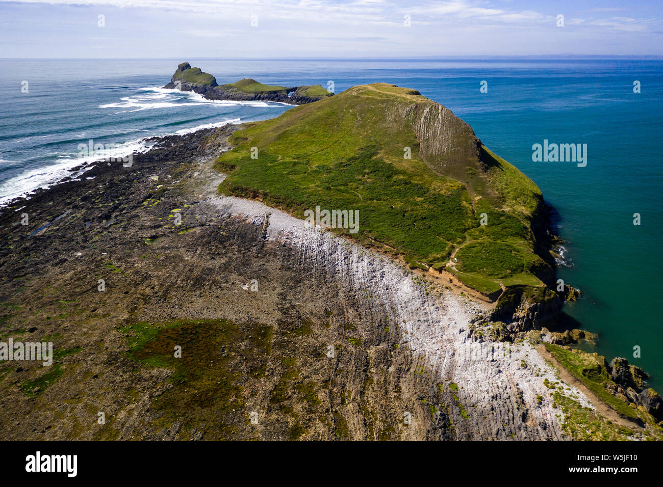 Aerial drone view of the rugged coastline and sea cliffs of Worm's Head ...