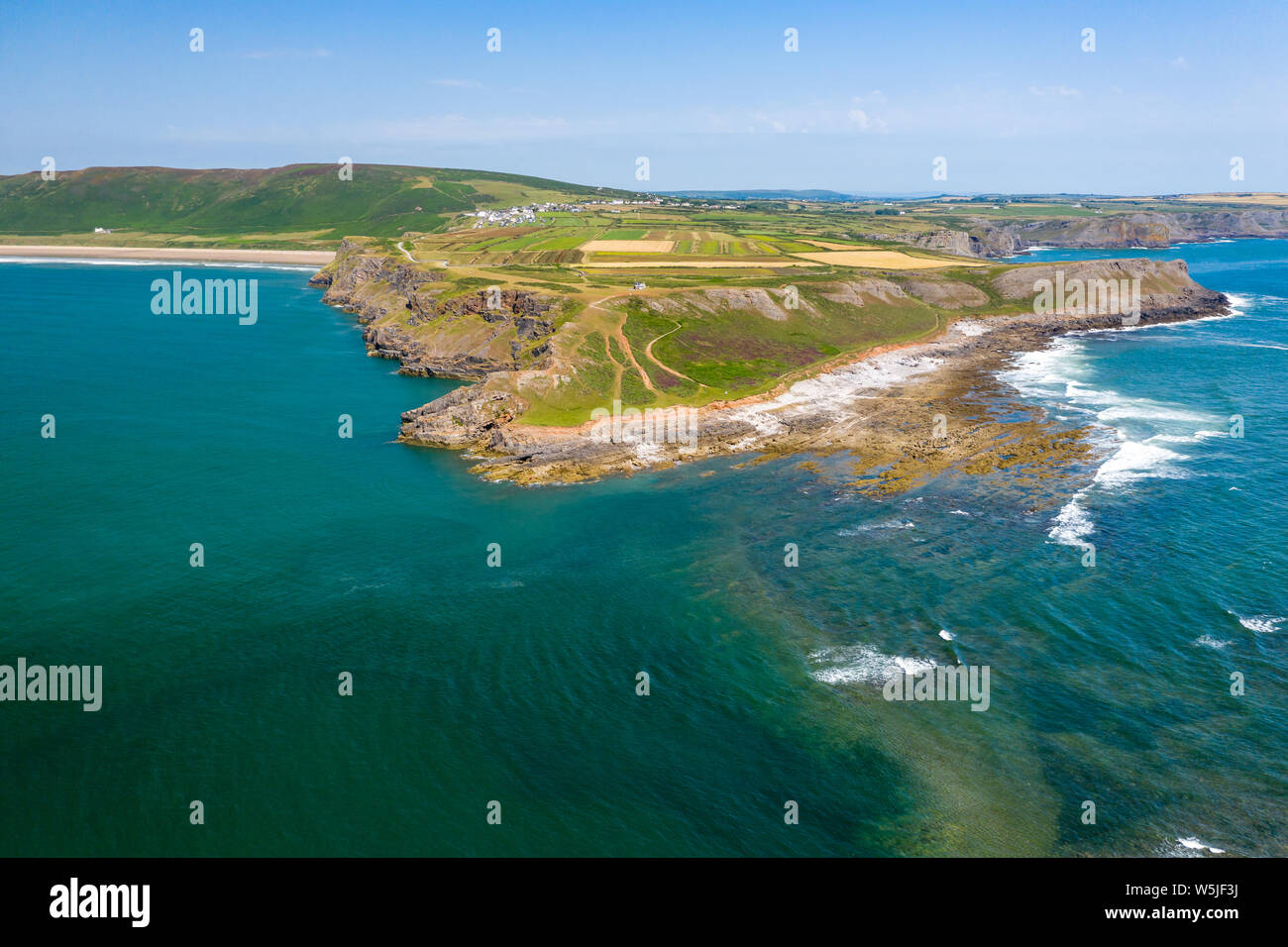 Aerial view of cliffs and waves on the Worm's Head area of the Gower ...