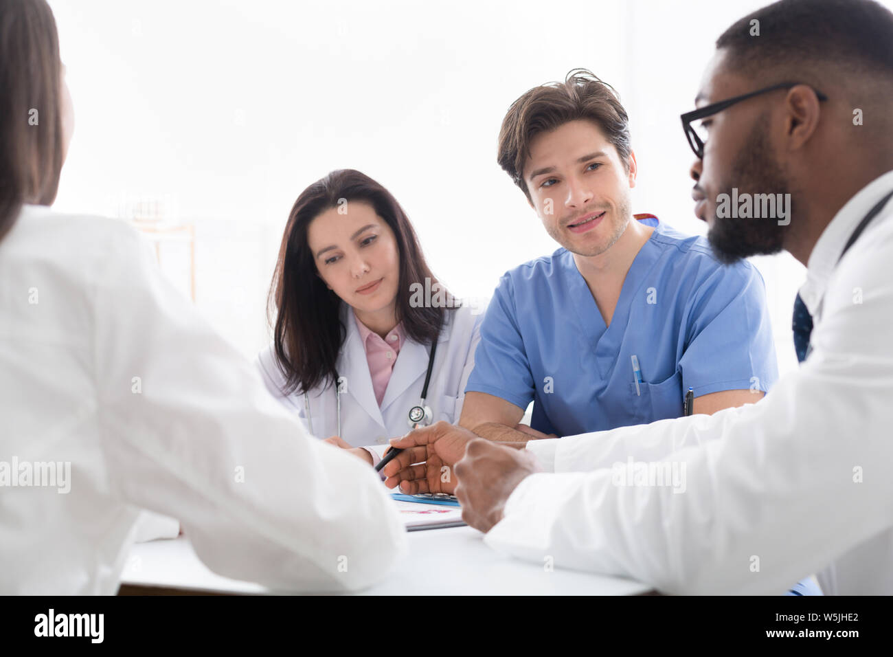 Doctors interacting at meeting in conference room Stock Photo - Alamy