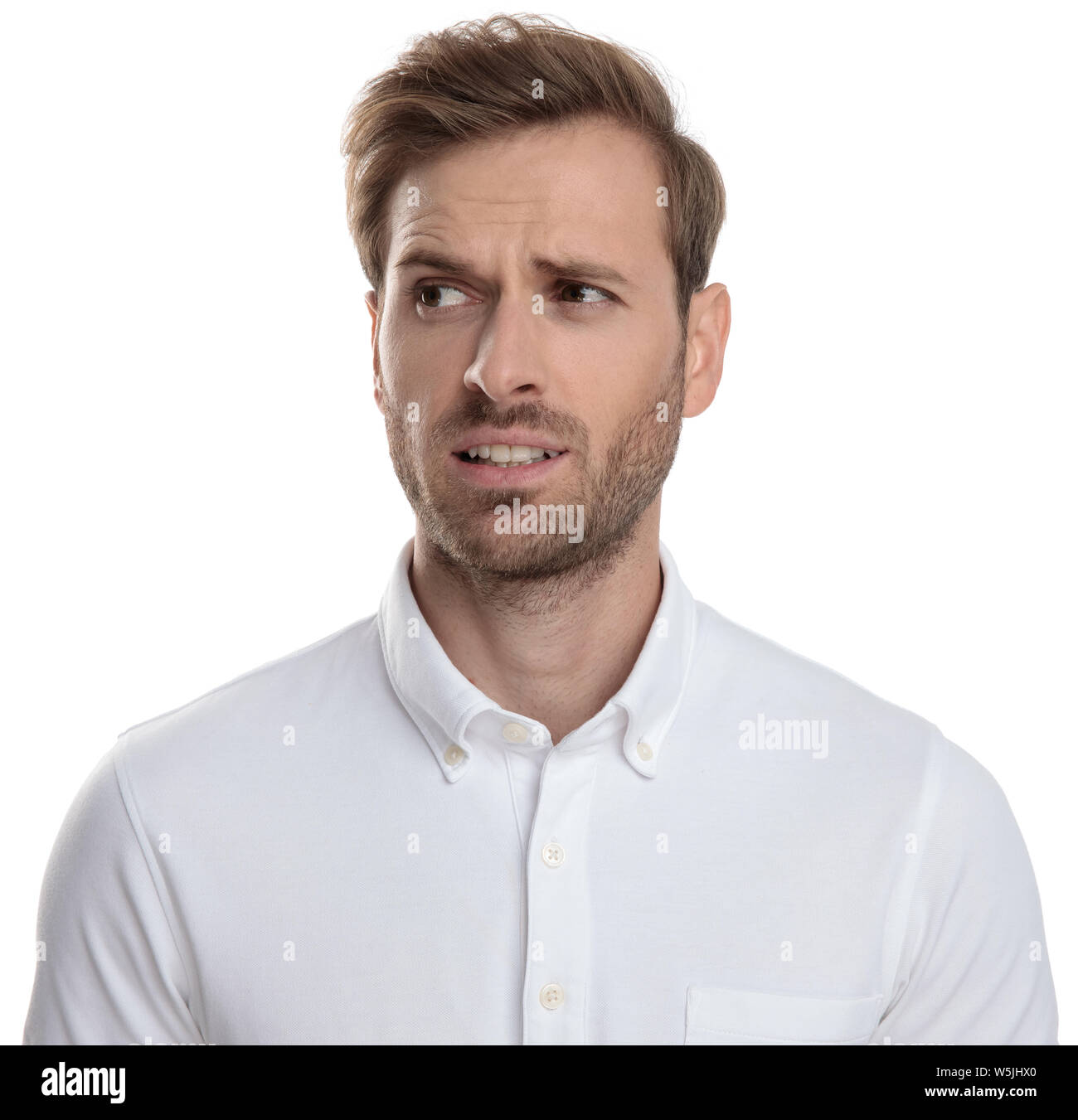 distracted man looks to side on white background Stock Photo - Alamy
