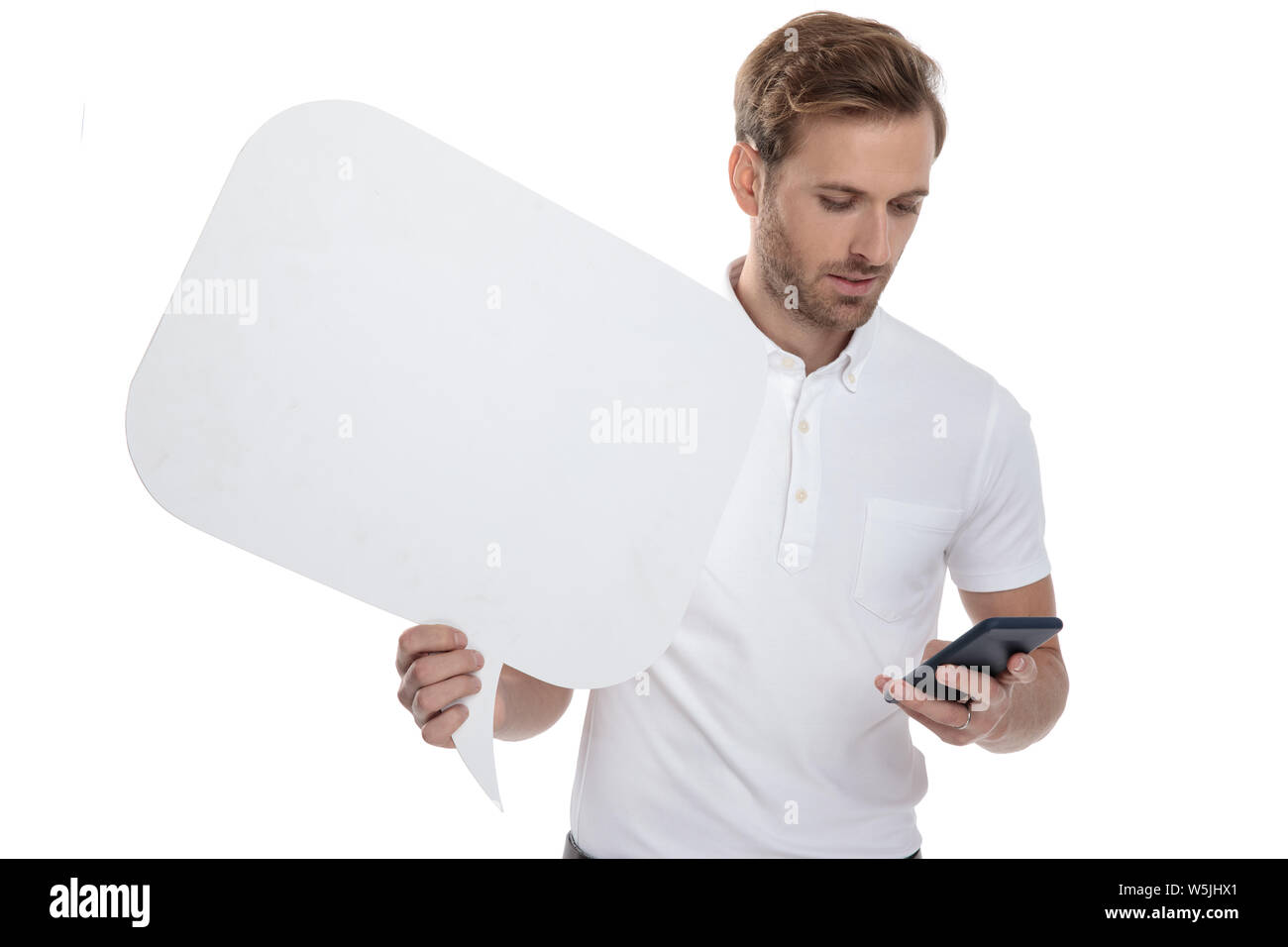 casual man reading a message on his phone while holding a speech bubble ...
