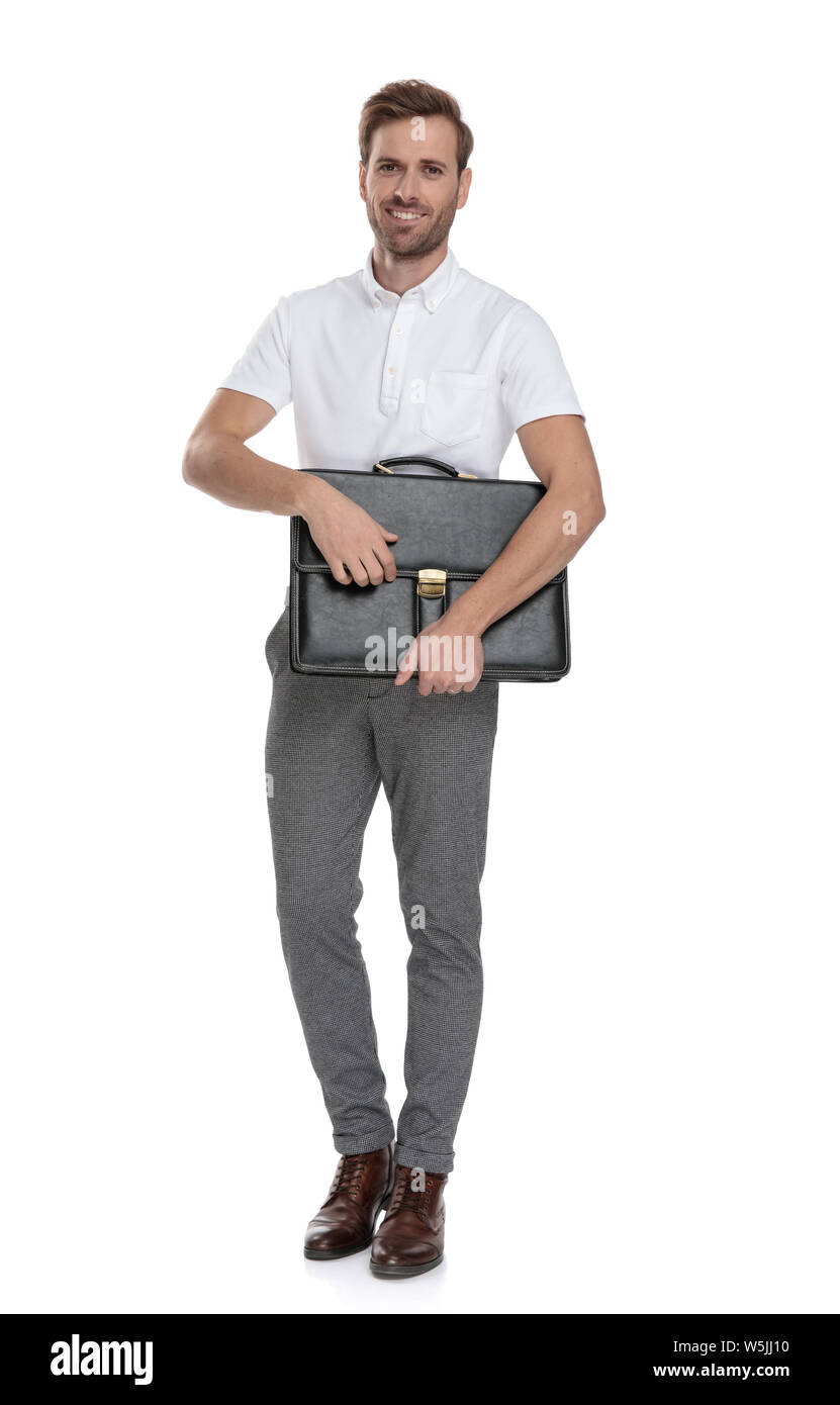happy casual man is opening his briefcase while standing on white ...