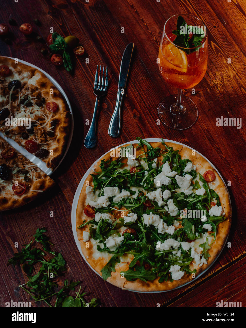 Pizza with cocktail on table silverware Stock Photo - Alamy