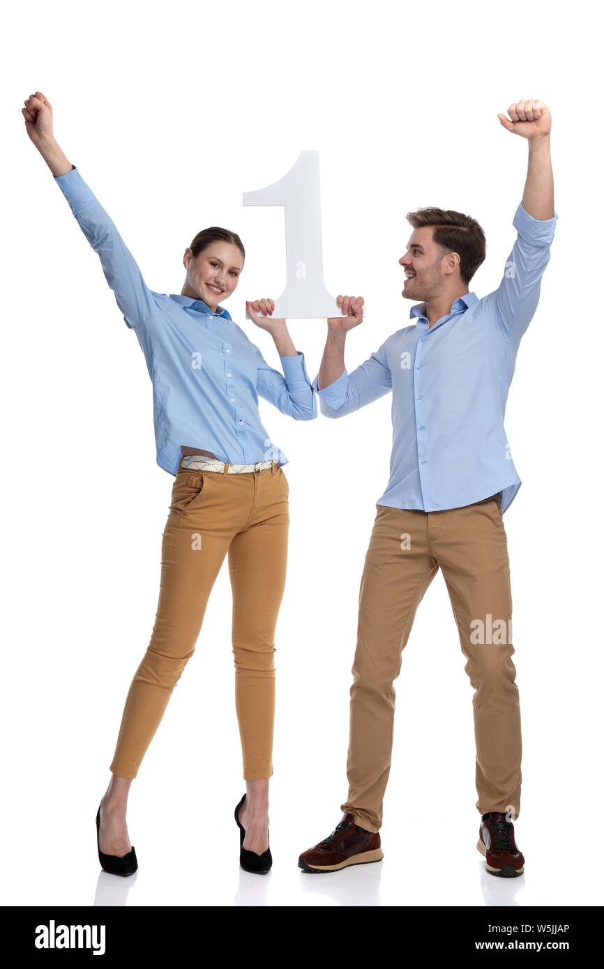 young casual couple celebrating being number one or first place on ...