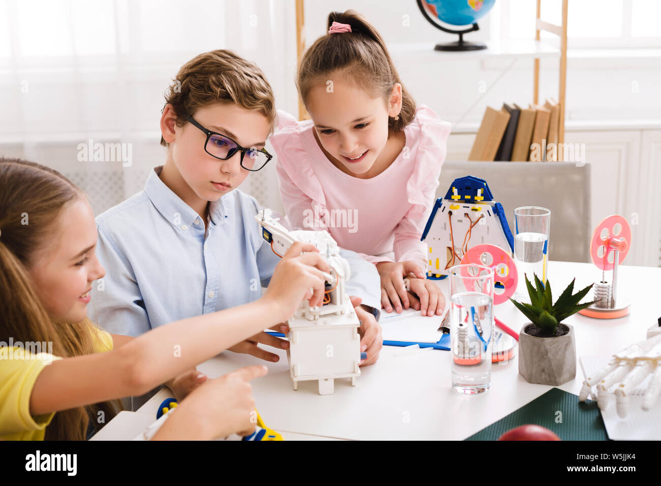 Stem education. Kids creating robots at school Stock Photo - Alamy