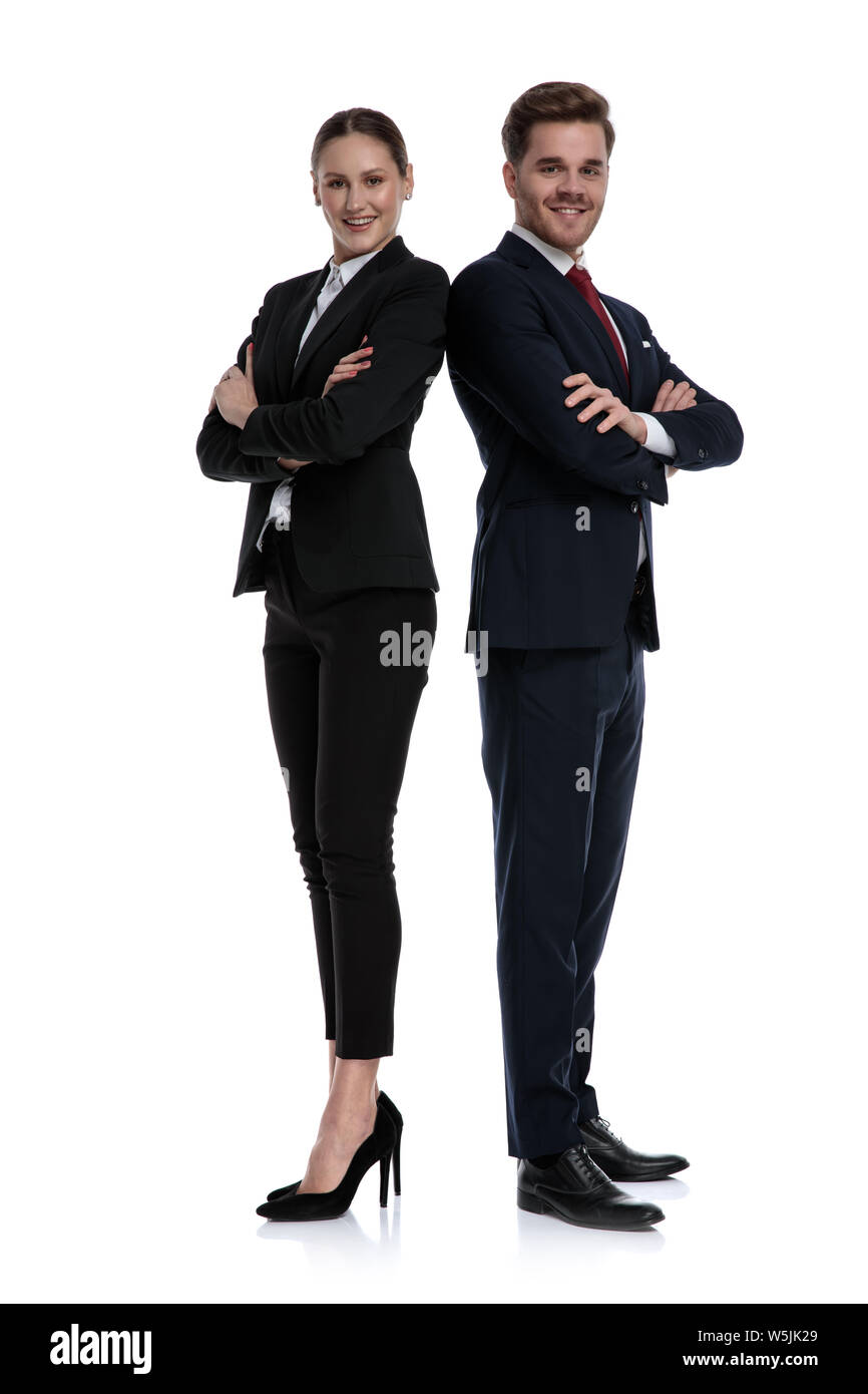 couple in business suits standing back to back with crossed arms on ...