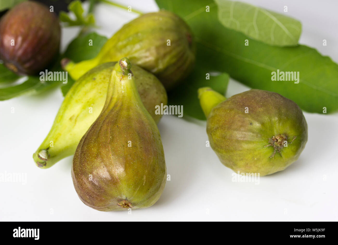 Ripe sweet figs on a white background Stock Photo - Alamy