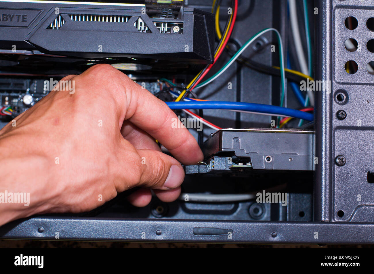 Computer repairing. Man repair black pc Stock Photo - Alamy