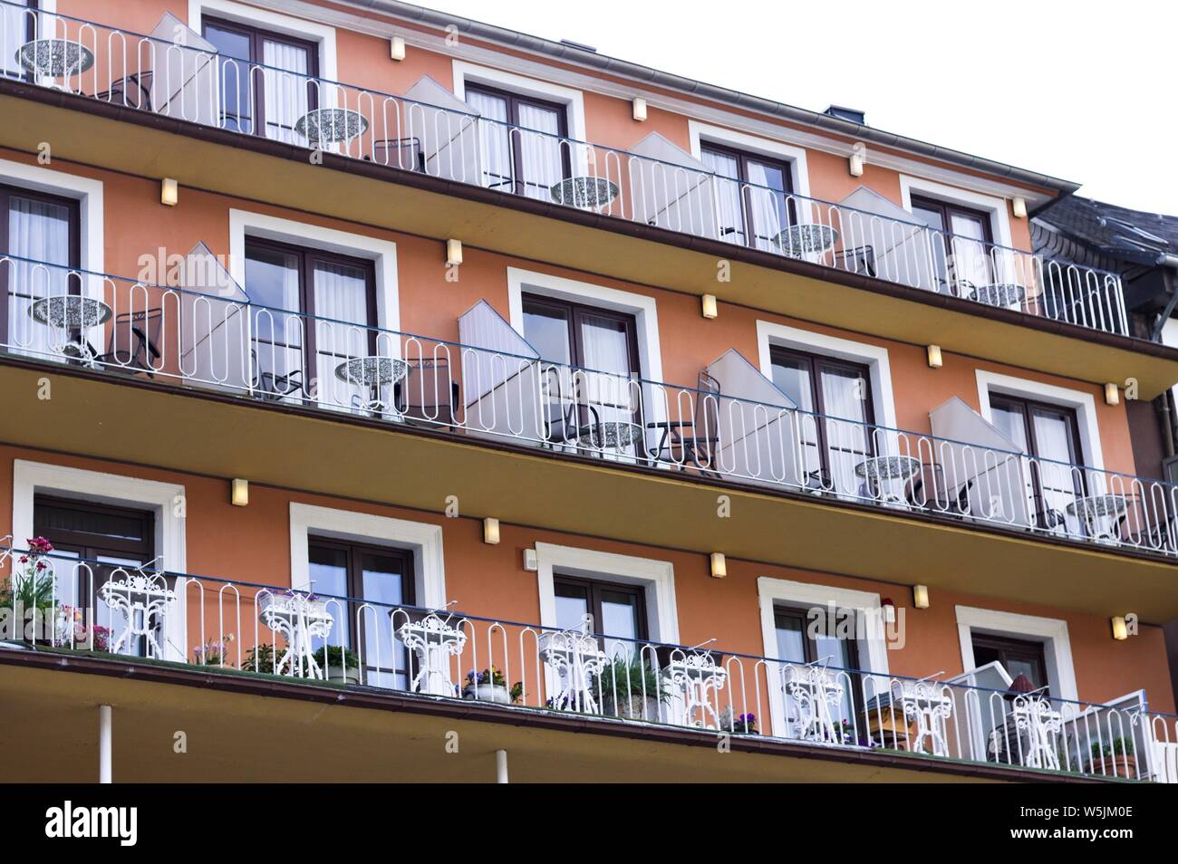 Orange facade of a german building with balcony and windows (Germany ...