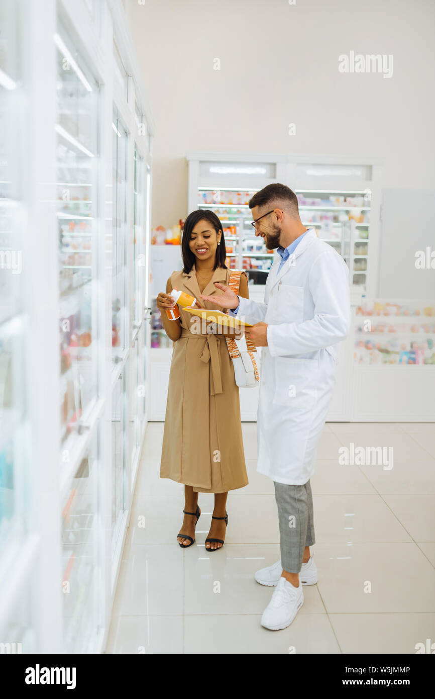 Positive delighted international client consulting with chemist Stock ...