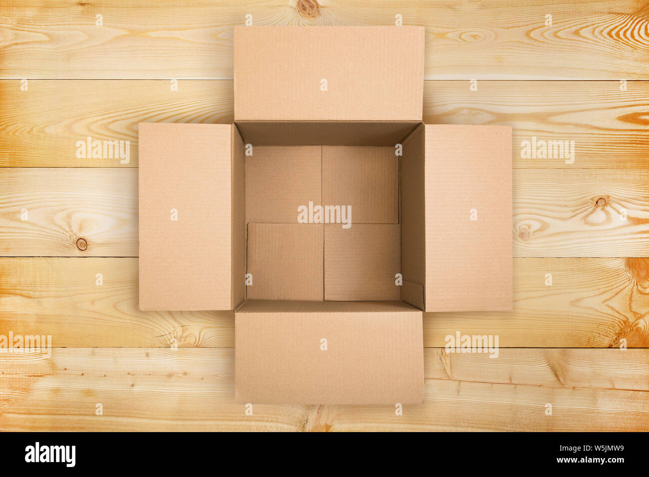 Open cardboard box on wooden plywood background. Corrugated carton box ...