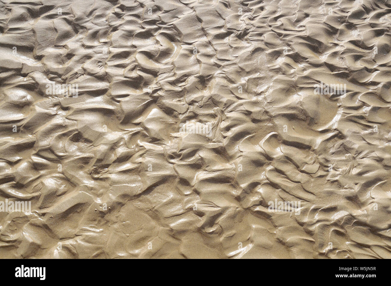 Abstract background of thin wet sand Stock Photo - Alamy