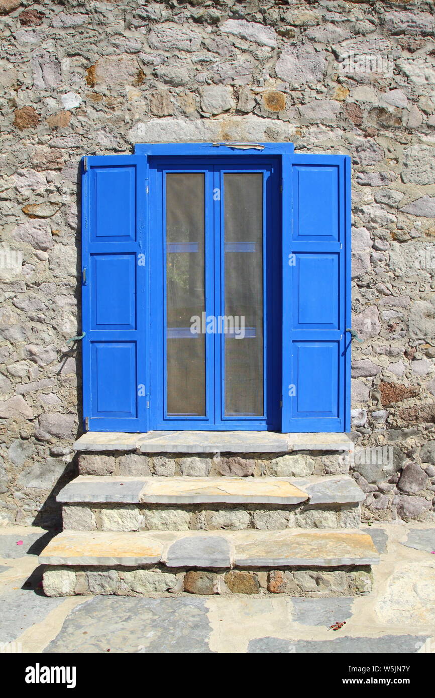 Open and closed light blue wooden window blinds on windows of newly ...