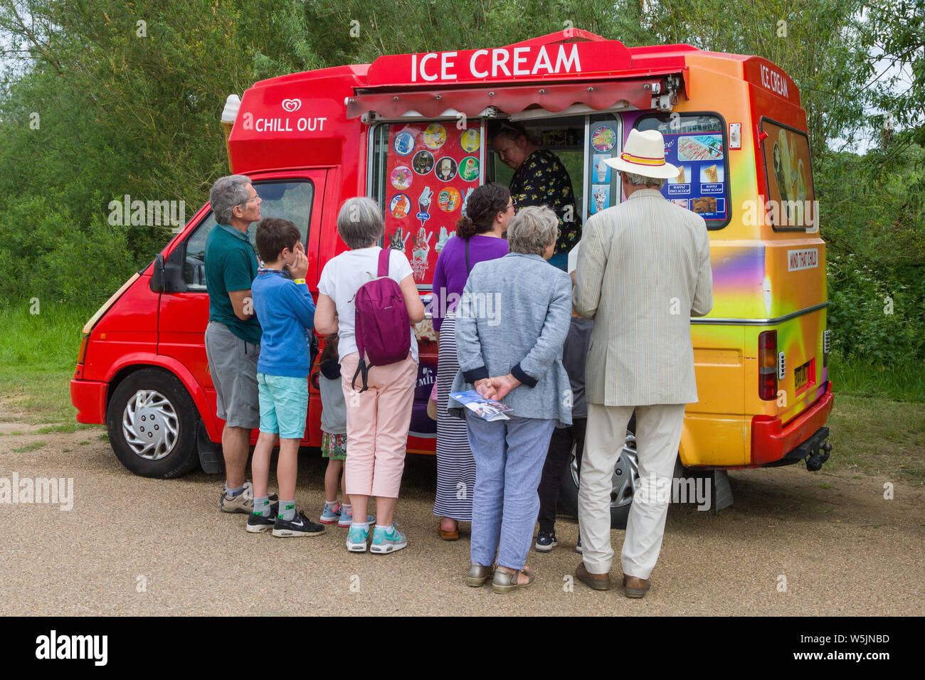 A group queue for ice creams at an ice cream van by the River Isis ...