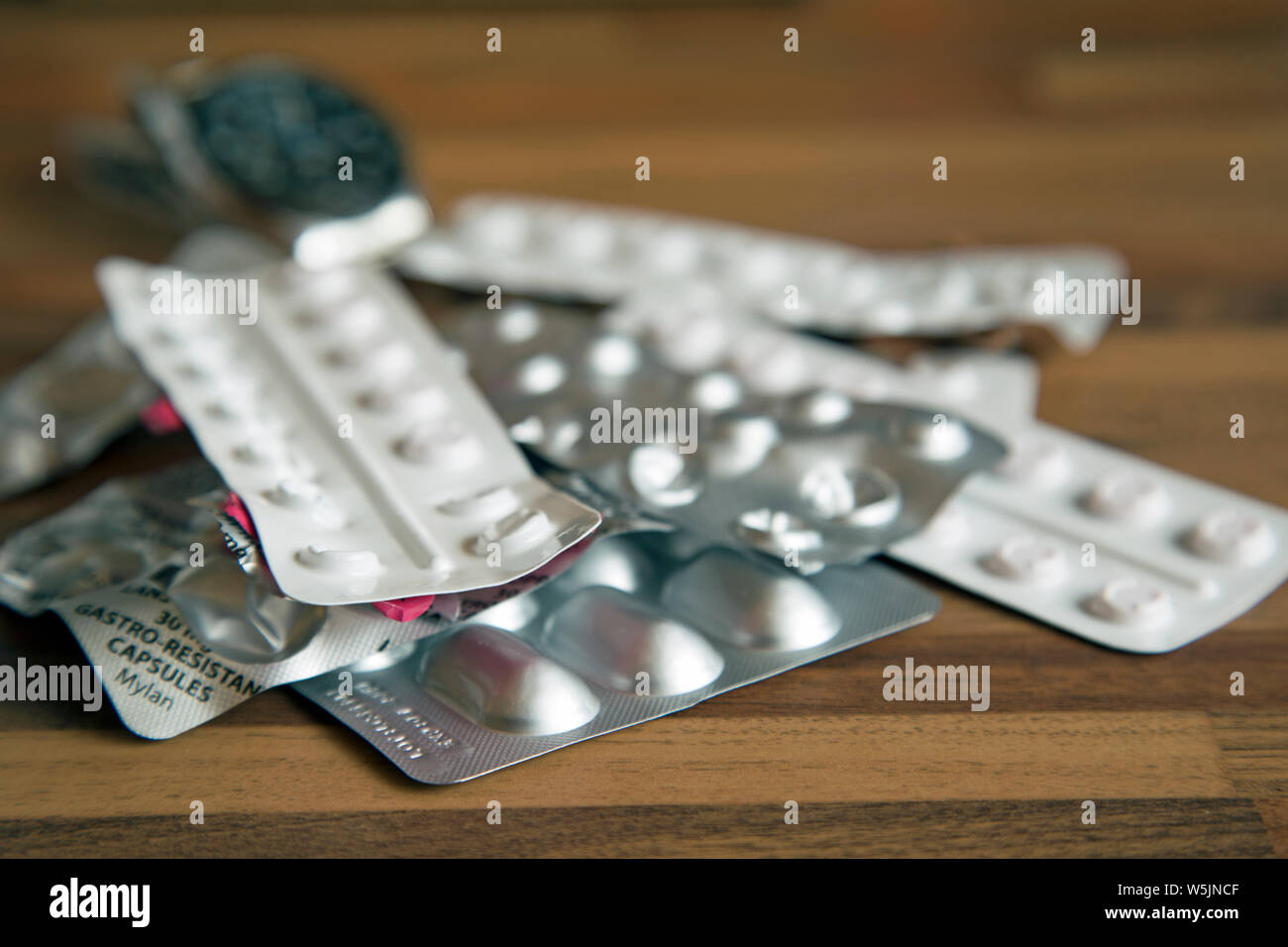 Tabletop photograph of several strips of prescription drugs with a ...