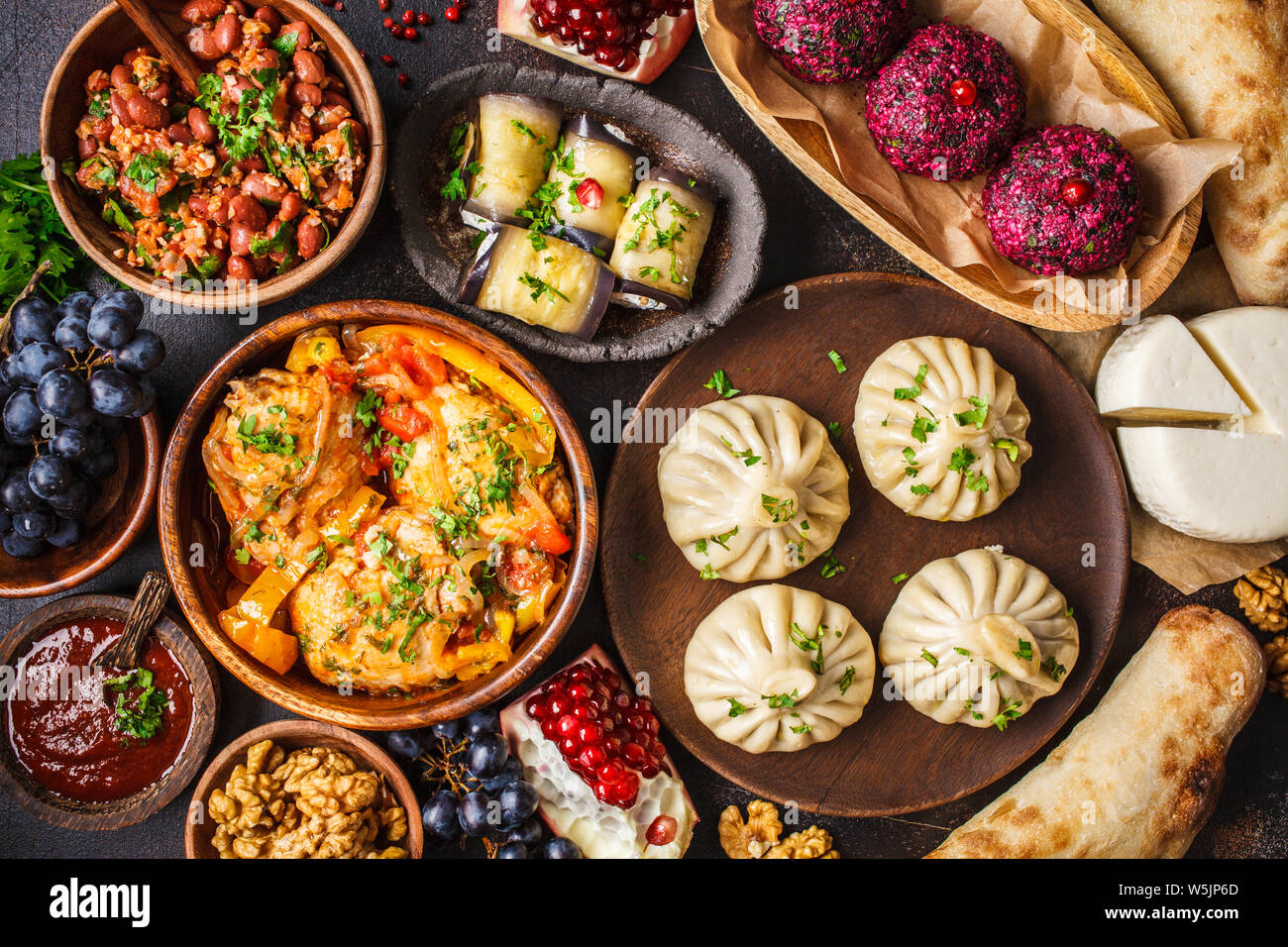Traditional Georgian cuisine background. Khinkali, phali, chahokhbili ...