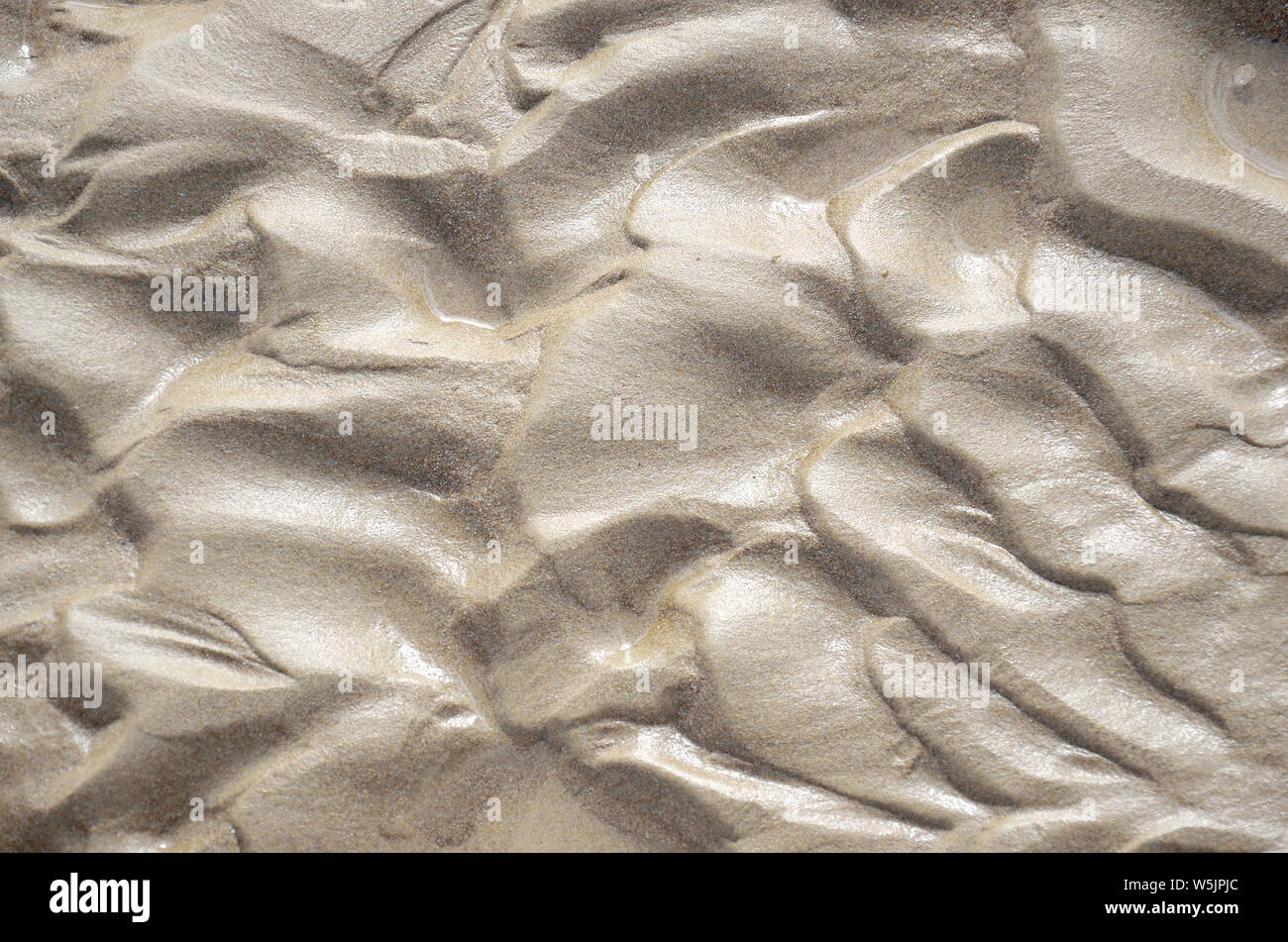 Abstract background of wet thin sand Stock Photo - Alamy