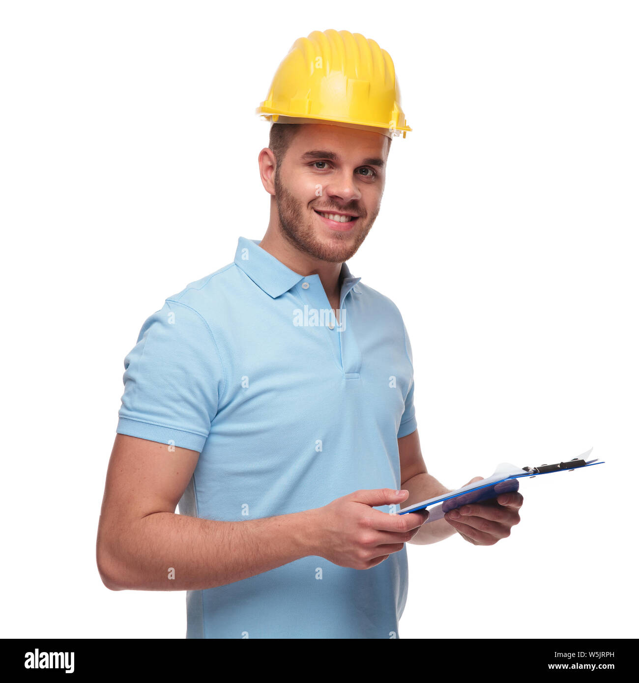 portrait of young engineer student holding blue clipboard while ...