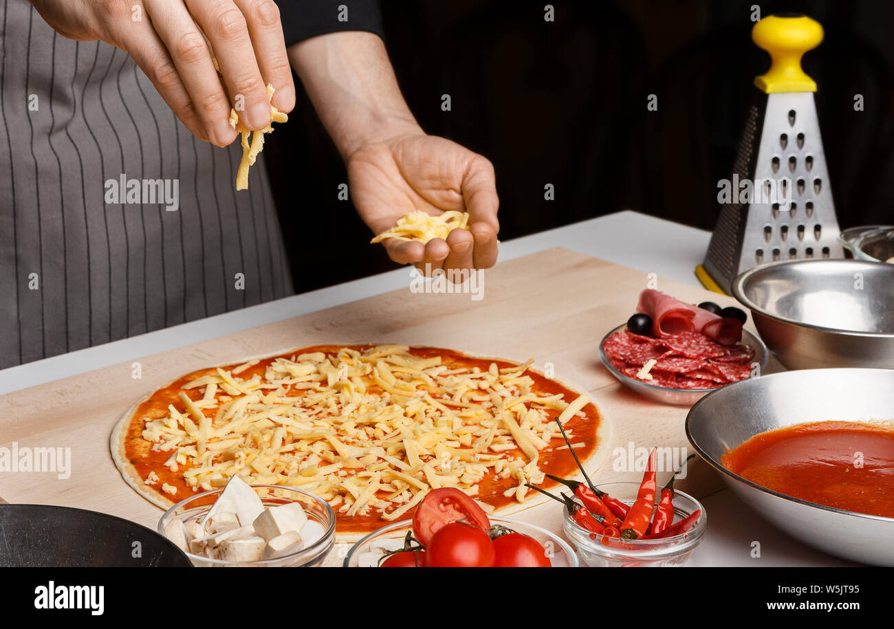 Male chef adding shredded hi-res stock photography and images - Alamy