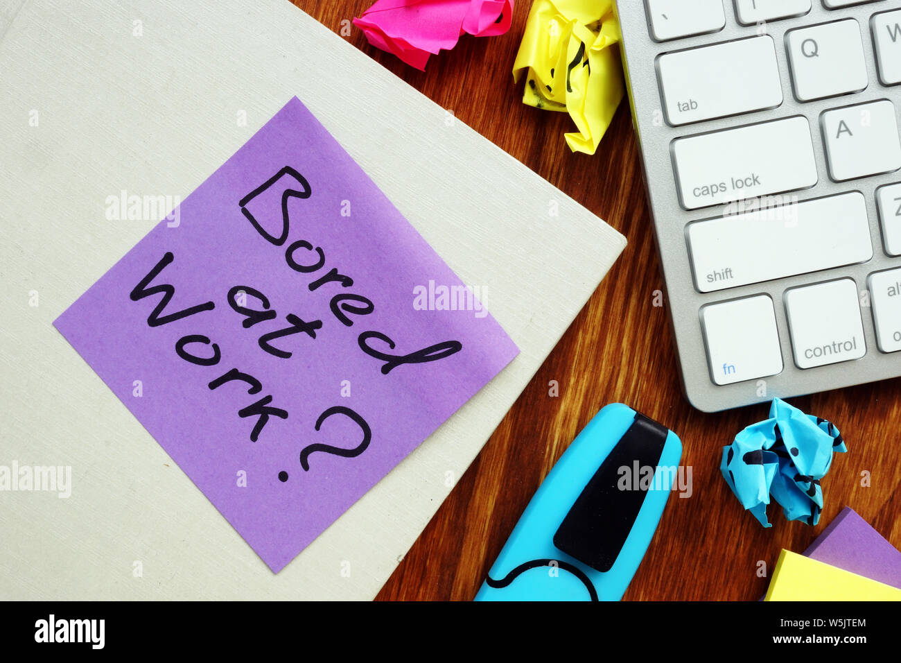 Bored at work Question about procrastination Stock Photo - Alamy