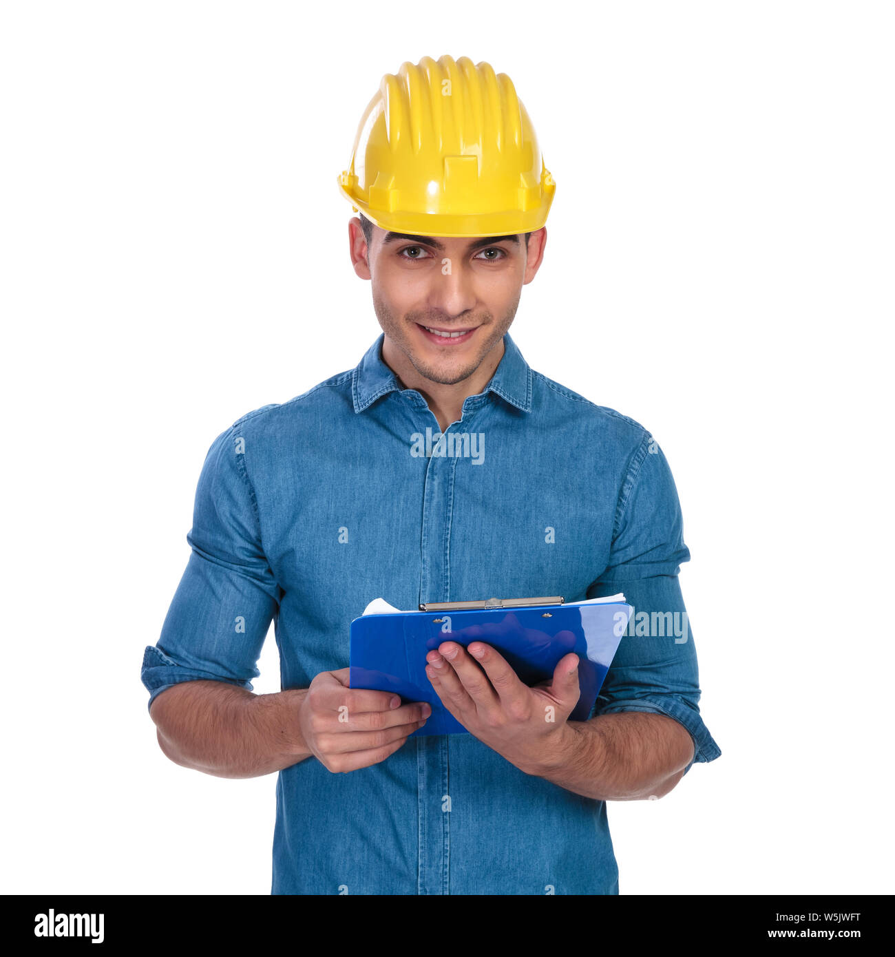 portrait of handsome engineer student holding blue clipboard while ...