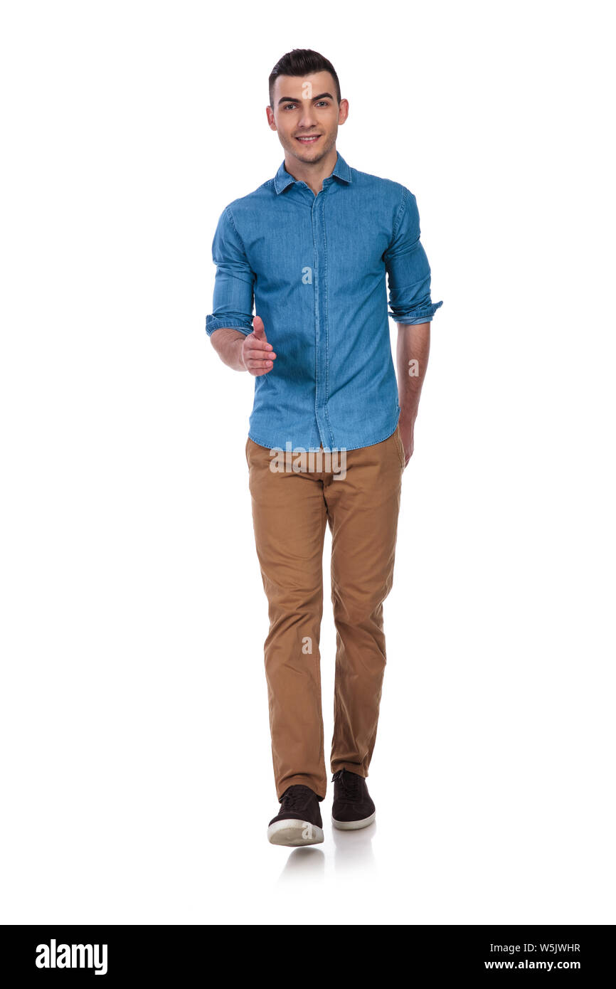 relaxed casual man walking forward on white background and making ok ...