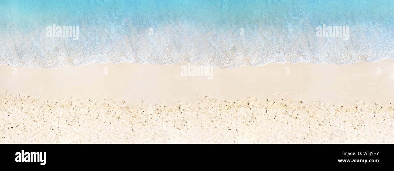 Clean image with sea beach edge and water hitting sand view from above ...