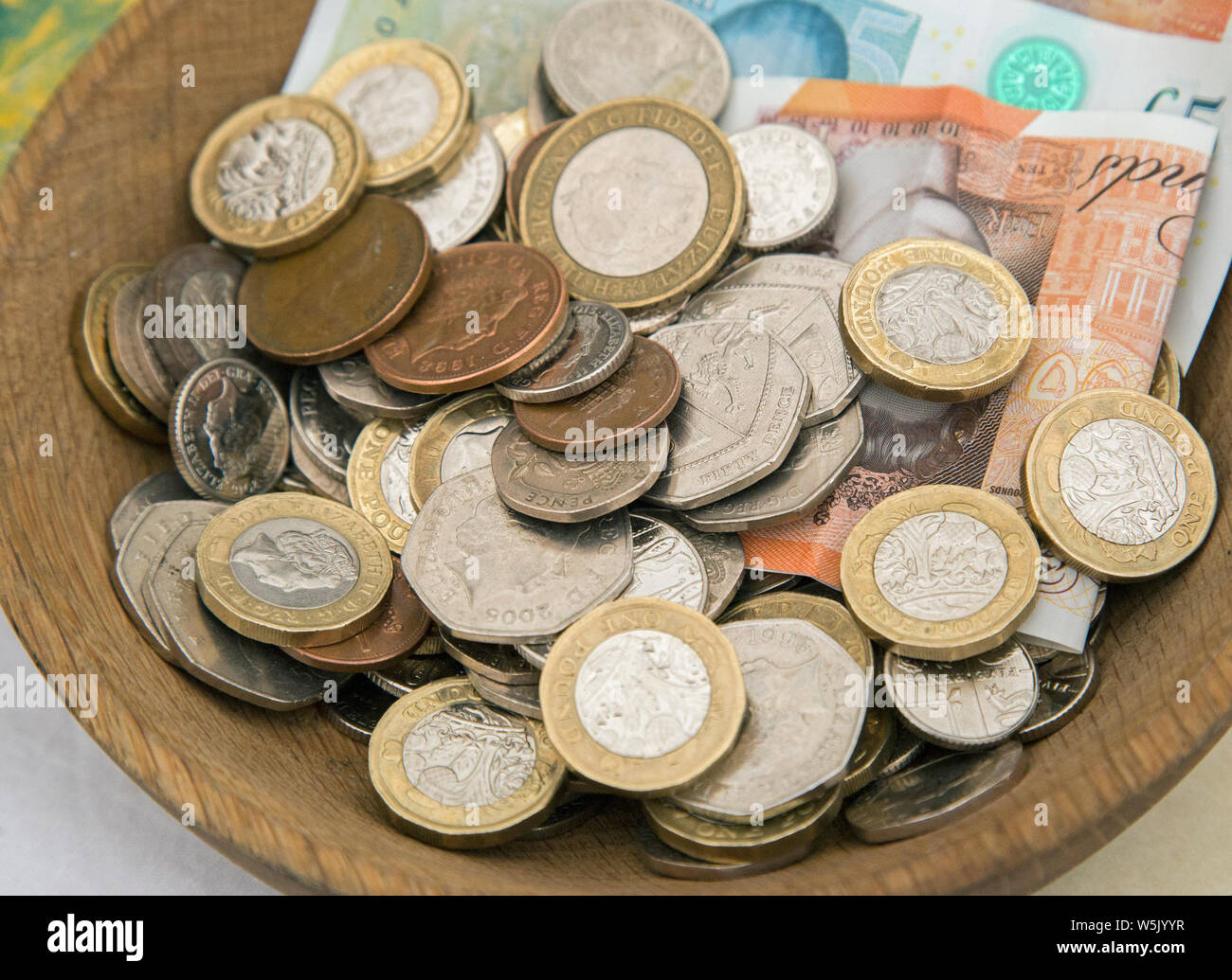 English money, in a dish shot close up as a background Stock Photo - Alamy