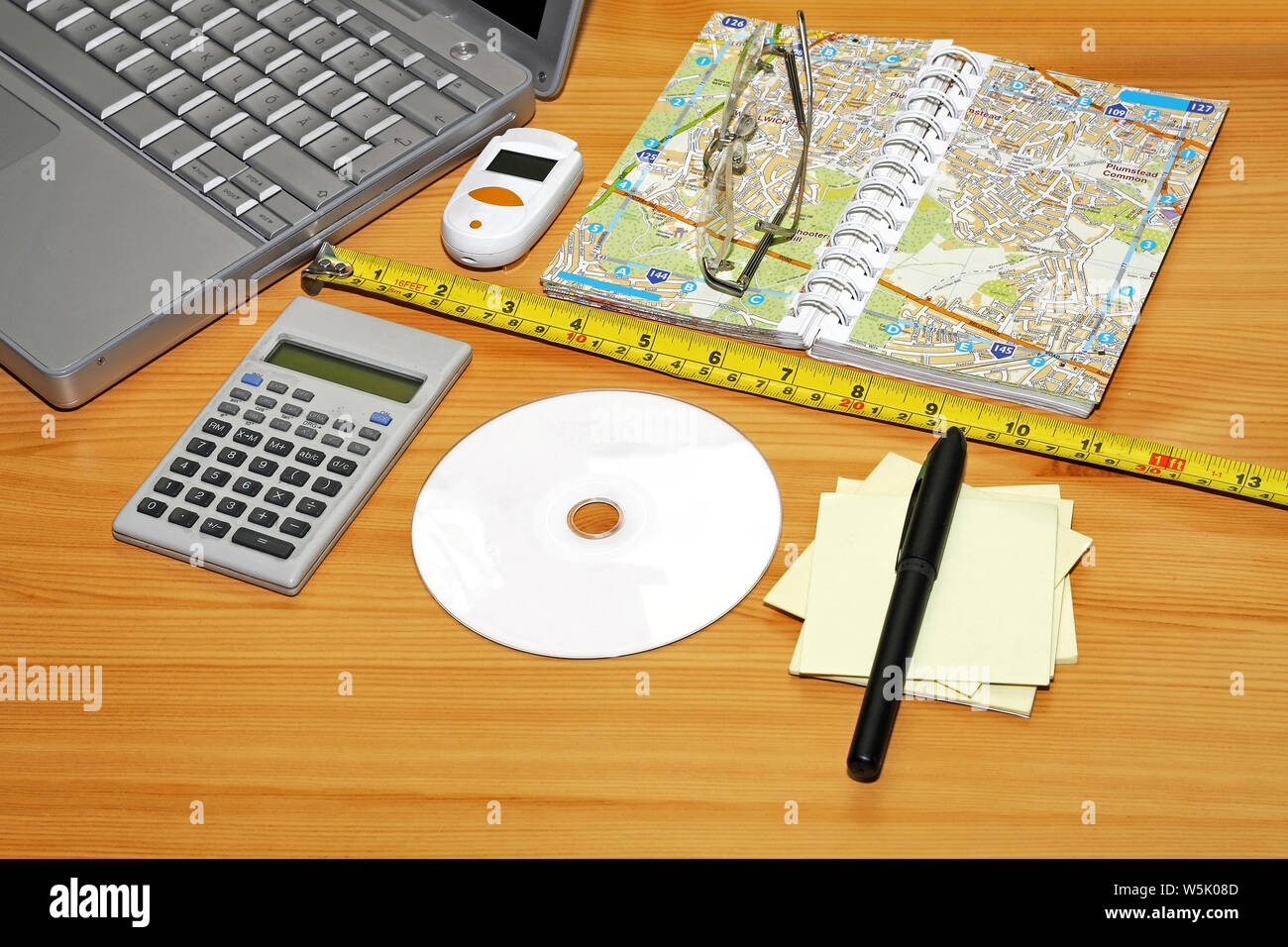 Notebook Map and Calculator at Wooden Desk Stock Photo - Alamy
